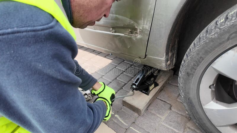A Guy Changes Tire on Street To Summer Tire in Nature Stock Video ...