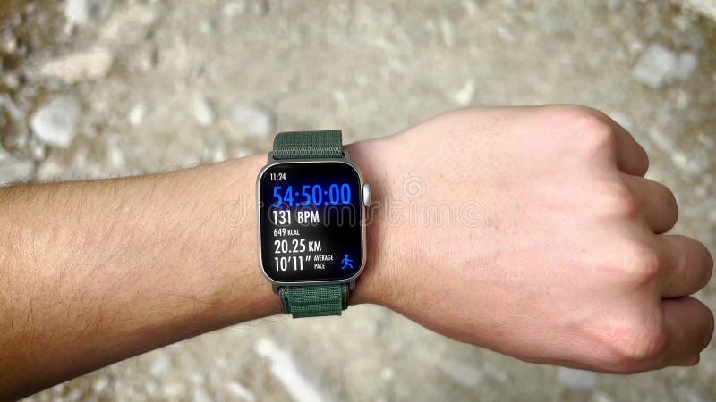 A Guy Checks the Status of His Running Training on His Smartwatch Using ...