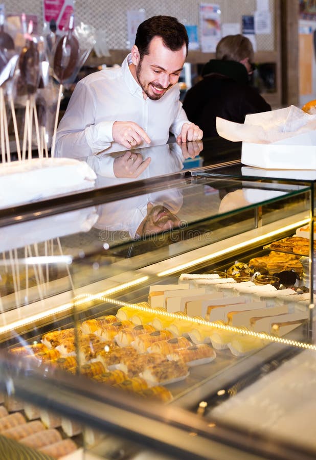 Guy chooses cakes stock photo. Image of search, indoors - 89220298