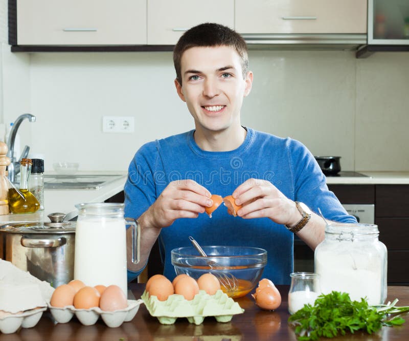 Guy cooking scrambled eggs stock photo. Image of handsome - 40032010