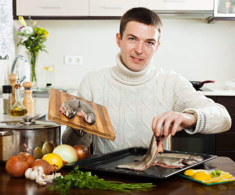 Guy cooking trout fish stock photo. Image of people, active - 36375012