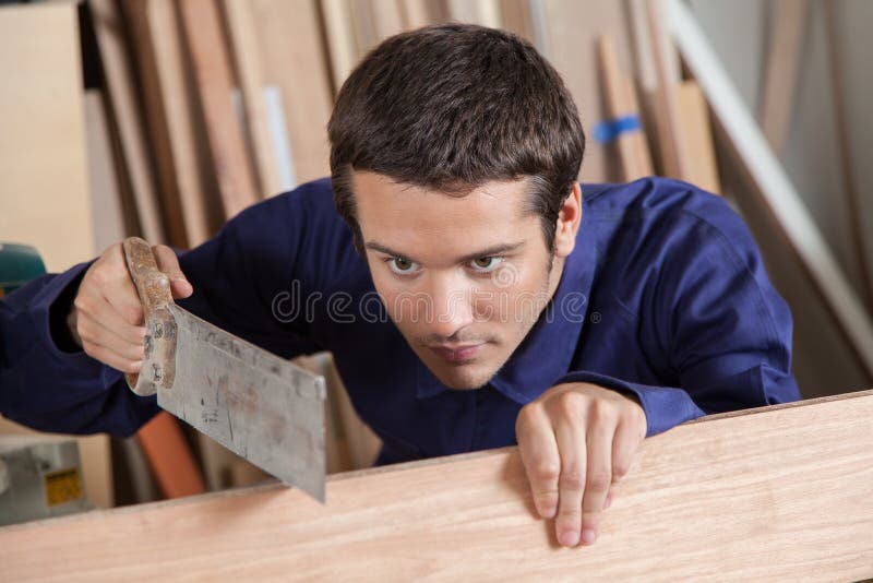 Guy Cutting a Piece of Wood Stock Photo - Image of hand, designs: 65258720