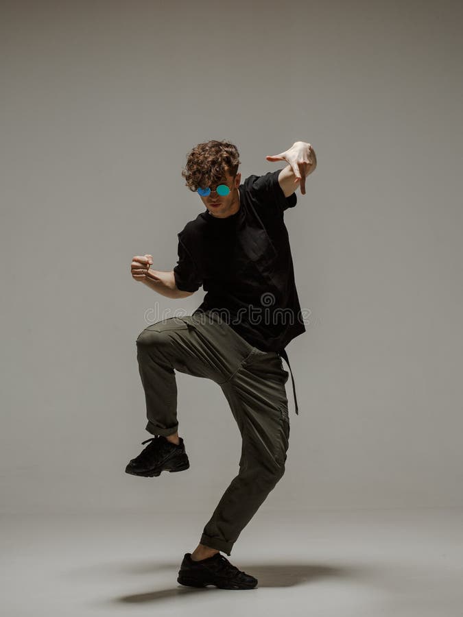 Guy Dancing Contemporary Dance in Studio. Neutral Grey Background ...