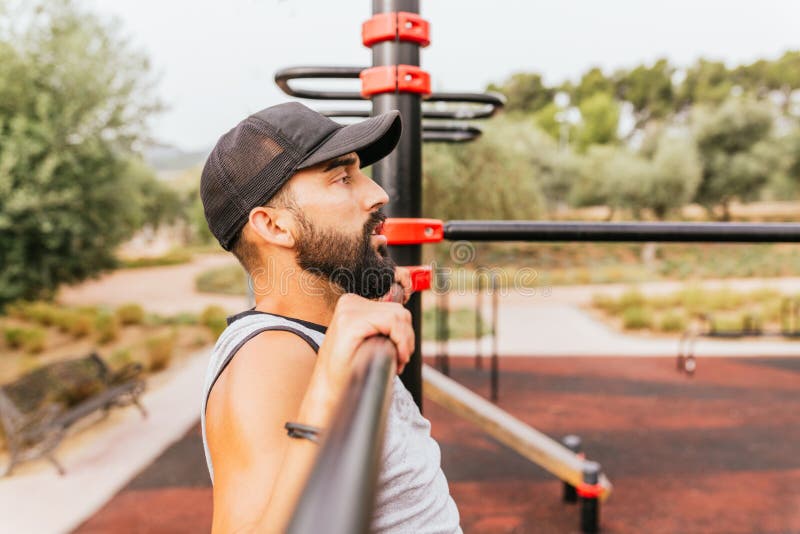 Guy doing pull-ups on pole stock photo. Image of appearance - 228242104