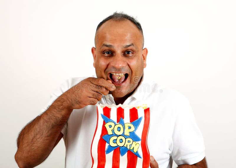 Guy eating popcorn stock photo. Image of eating, time - 15568418