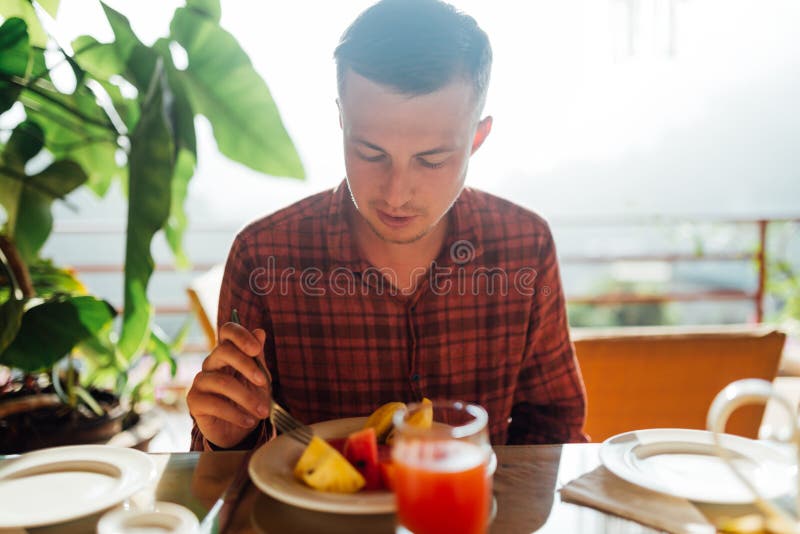 Guy Eats Breakfast from Fruit on a Sunny Terrace Stock Photo - Image of ...
