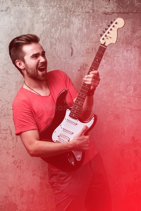 Guy with Electric Guitar beside Concrete Wall Stock Image - Image of ...