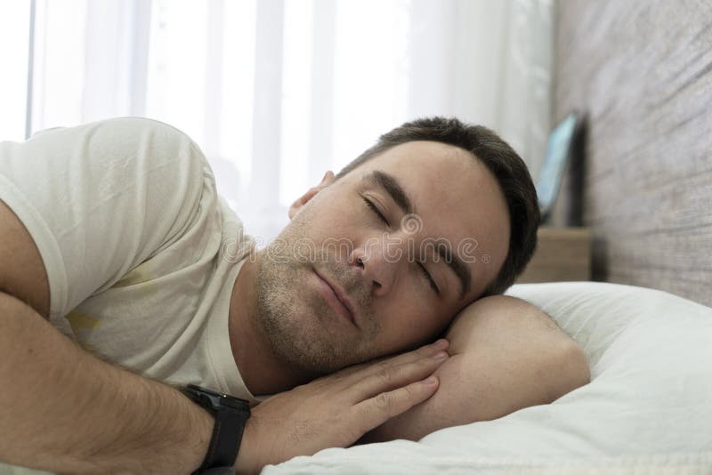 The Guy Enjoys Sleeping on the Background of the Window in the Morning. an Interesting Dream ...