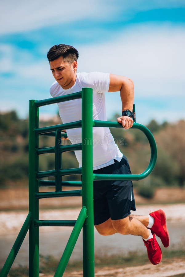 Guy Exercising Arms Doing Hard Exercises on Metal Bars Stock Image ...