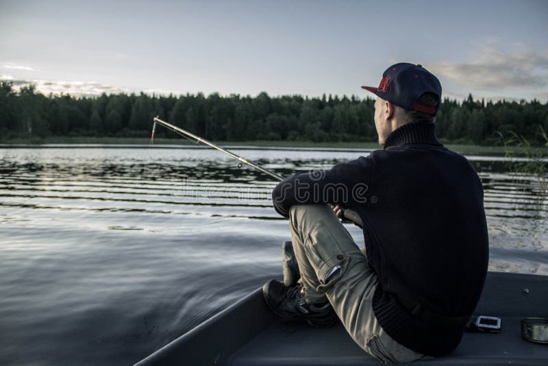 A Guy with a Fishing Rod is Fishing Stock Photo - Image of lilies ...