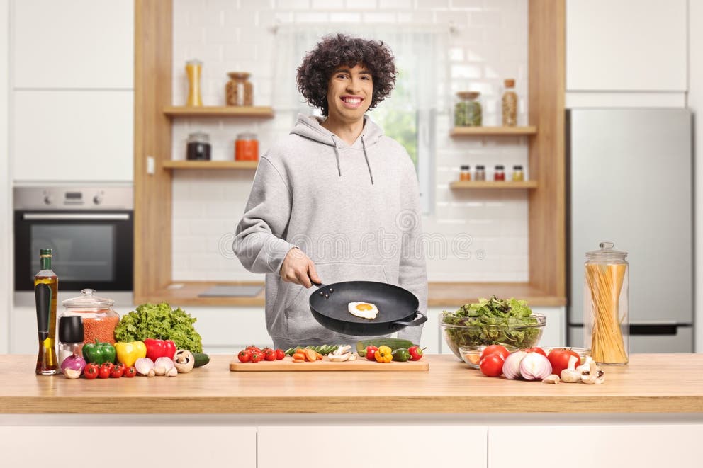 Guy frying an egg in a pen stock image. Image of dish - 362166381