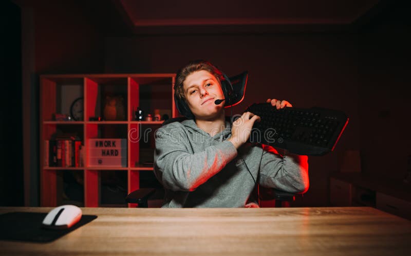 Guy Gamer with a Keyboard on His Shoulder Playing Online Games on the ...