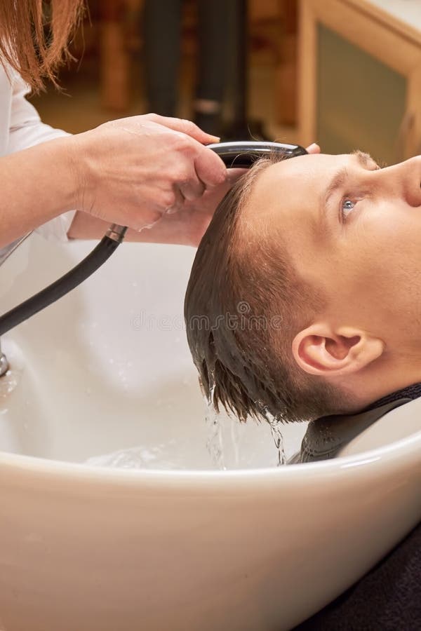 Guy getting head washed. stock image. Image of female - 100150607