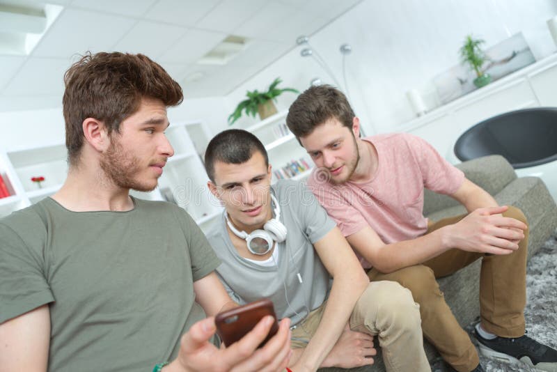 Guy Getting Together and Watching Funny Stuff on Internet Stock Photo ...