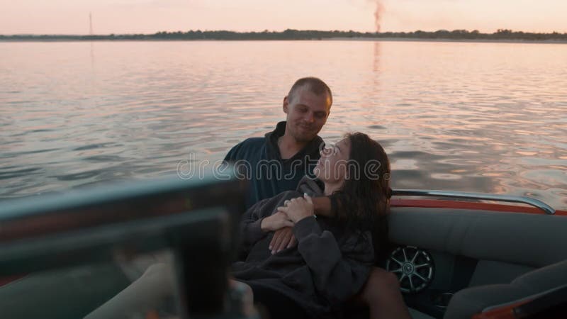 A Guy and a Girl Cuddle Cute at Sunset Sitting in a Boat Stock Footage ...