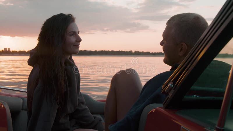 A Guy and a Girl Cuddle Cute at Sunset Sitting in a Boat Stock Footage ...
