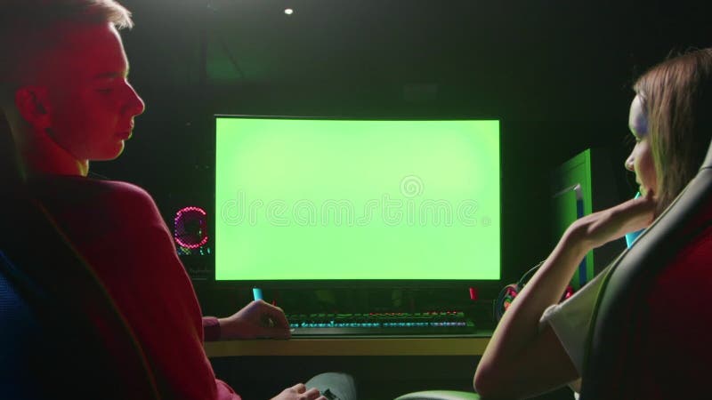 Two Guys are Sitting at a Computer and Looking at a Green Screen Stock ...