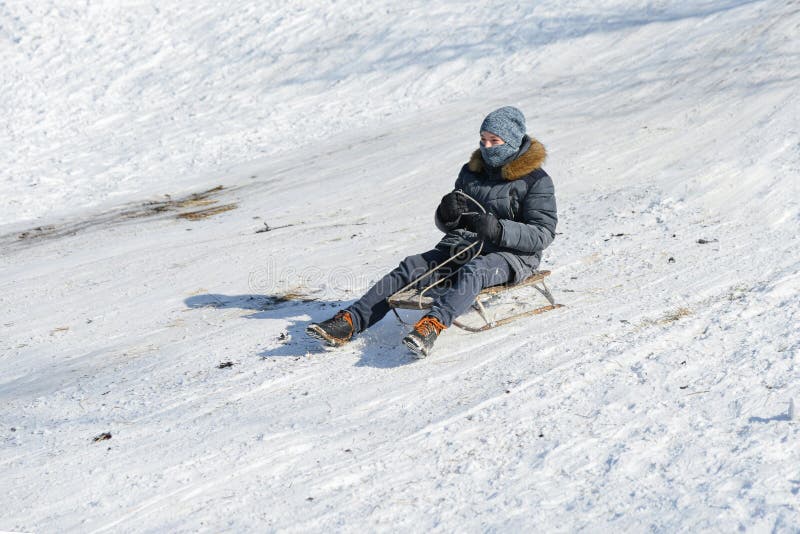 The Guy Goes Down on a Sled on a Slippery Snow Slide Stock Image ...