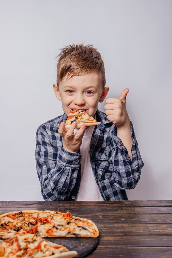 The Guy with Great Pleasure Eats a Piece of Pizza Stock Photo - Image ...