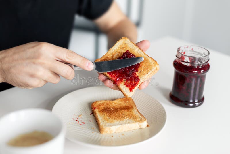 The Guy Has Breakfast with Toast with Jam Stock Photo - Image of ...