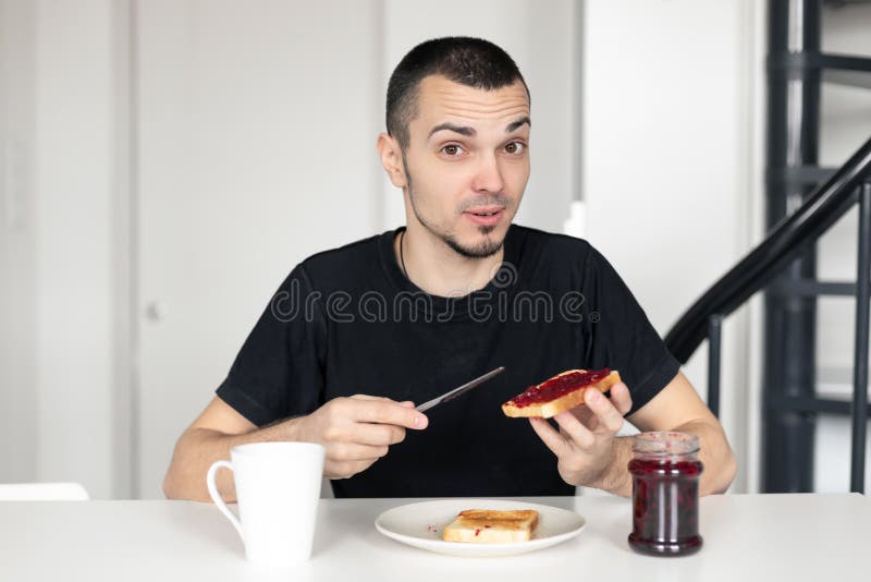 The Guy Has Breakfast with Toast with Jam Stock Image - Image of eating ...