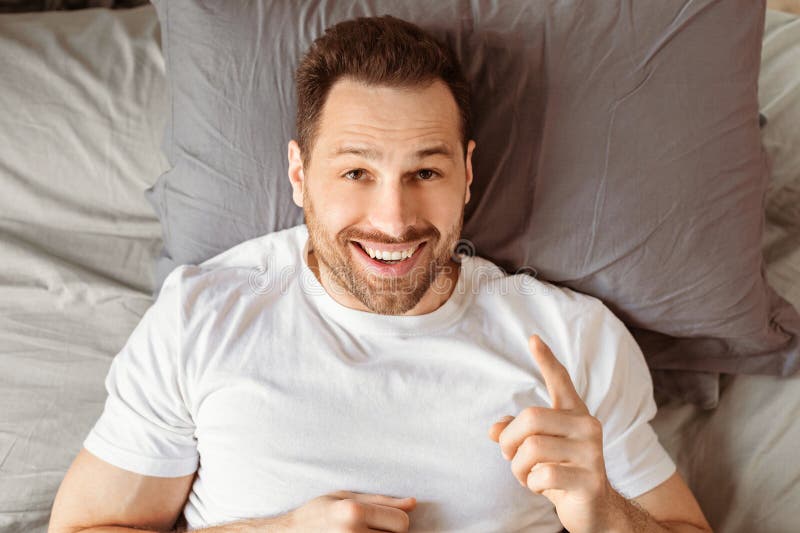 Guy Having Idea Pointing Finger Up Lying in Bed, Top-View Stock Image ...