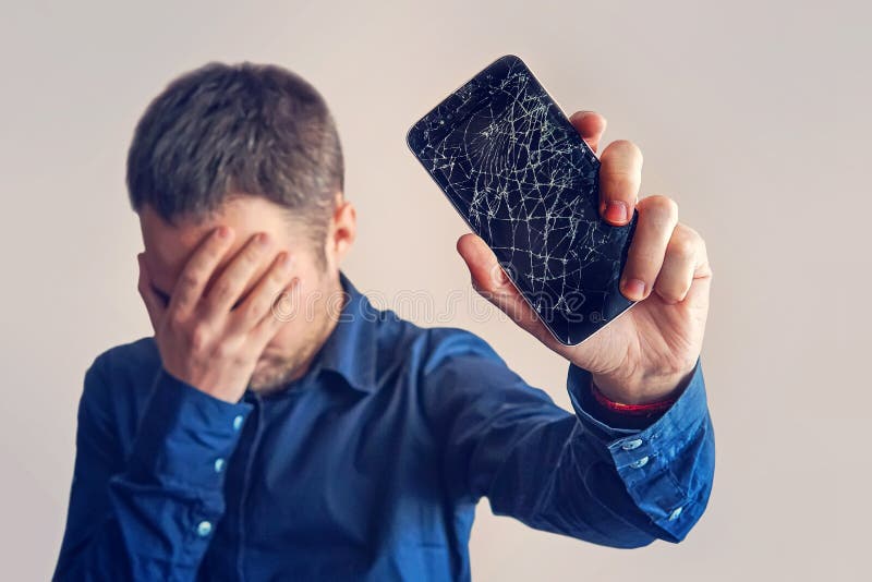 The Guy is Holding a Black Smartphone with a Broken Display. Stock ... The Guy is Holding a Black Smartphone with a Broken Display. Stock ...