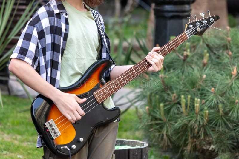 The Guy is Holding an Electric Bass Guitar in His Hands Stock Image ...