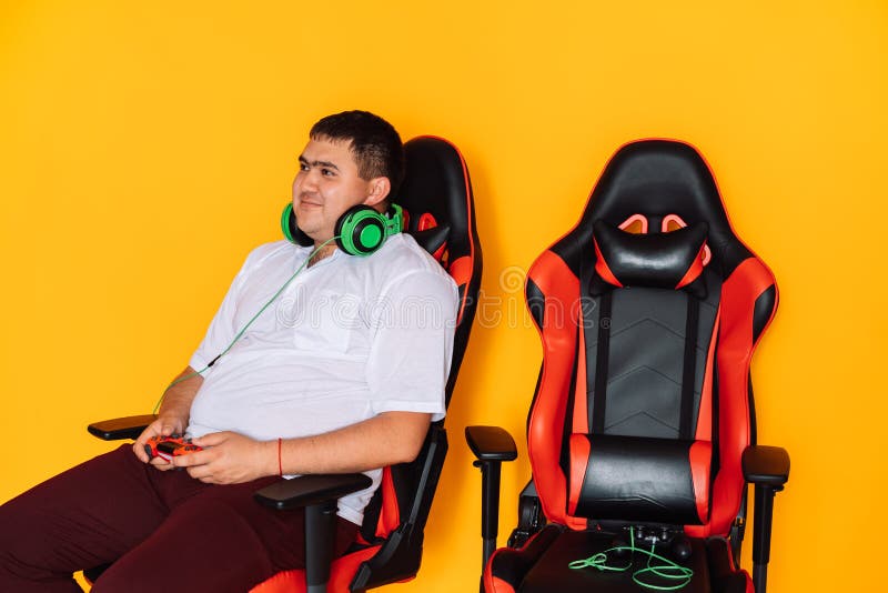 Guy Holding Game Controller Playing Video Games while Sitting on Gaming ...