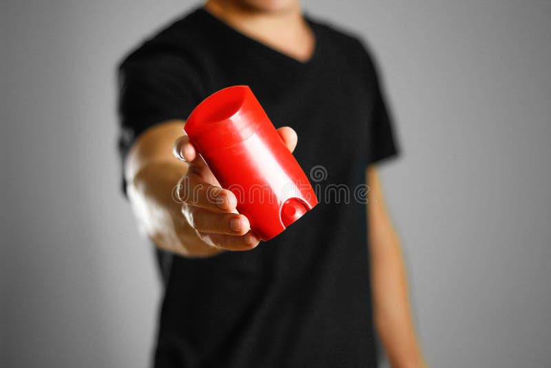 The Guy is Holding a Red Deodorant. Shows a Deodorant Stock Photo ...