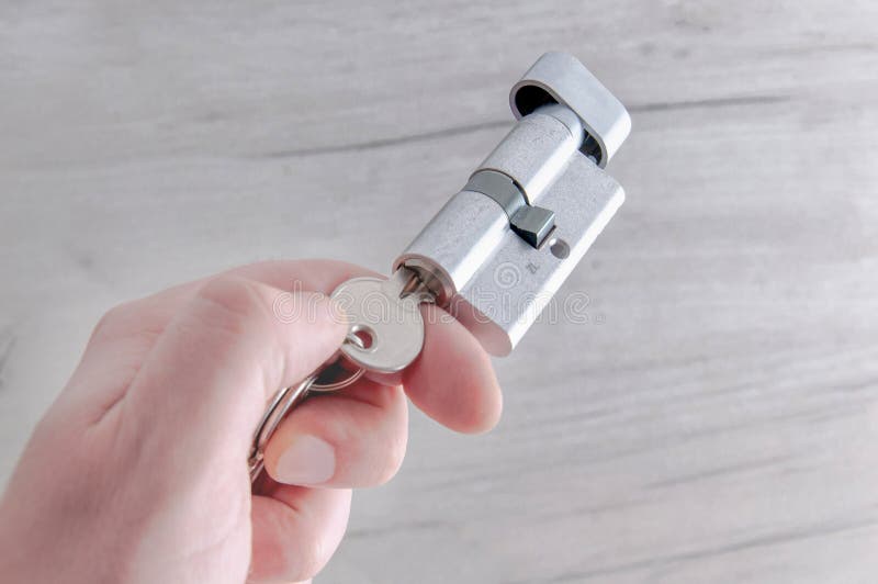 The Guy Holds In His Hand The Core Of The Lock From The Door On A Light ...