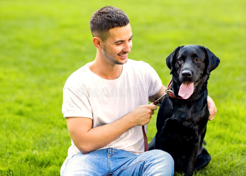 Guy Hugging with His Dog Labrador Playing in the Park Stock Image ...