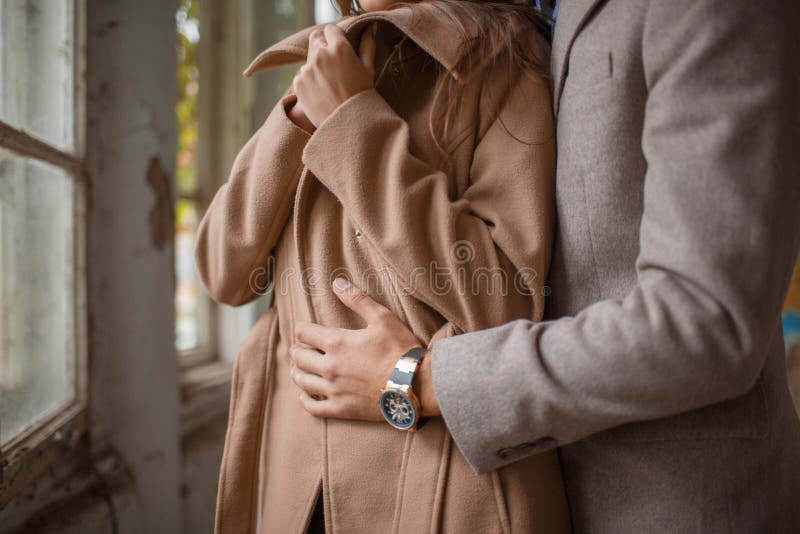 The Guy Hugs The Girl From Behind On The Hand Of The Guy Watch Stock