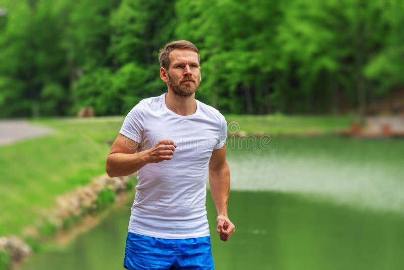 Guy jogging outdoors. stock image. Image of training - 270962543