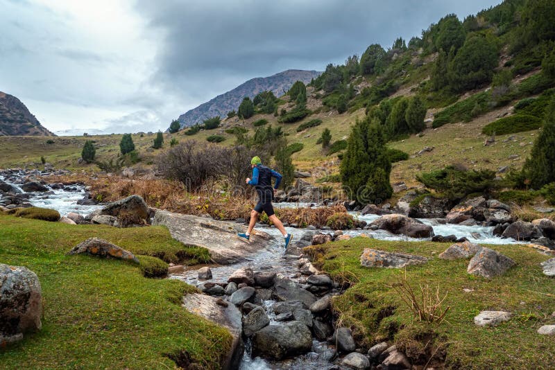 A Guy Jogs Across a Mountain River Stock Photo - Image of people ...