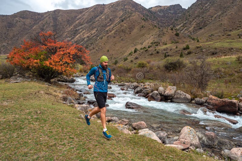 A Guy Jogs Across a Mountain River Stock Photo - Image of exercise ...