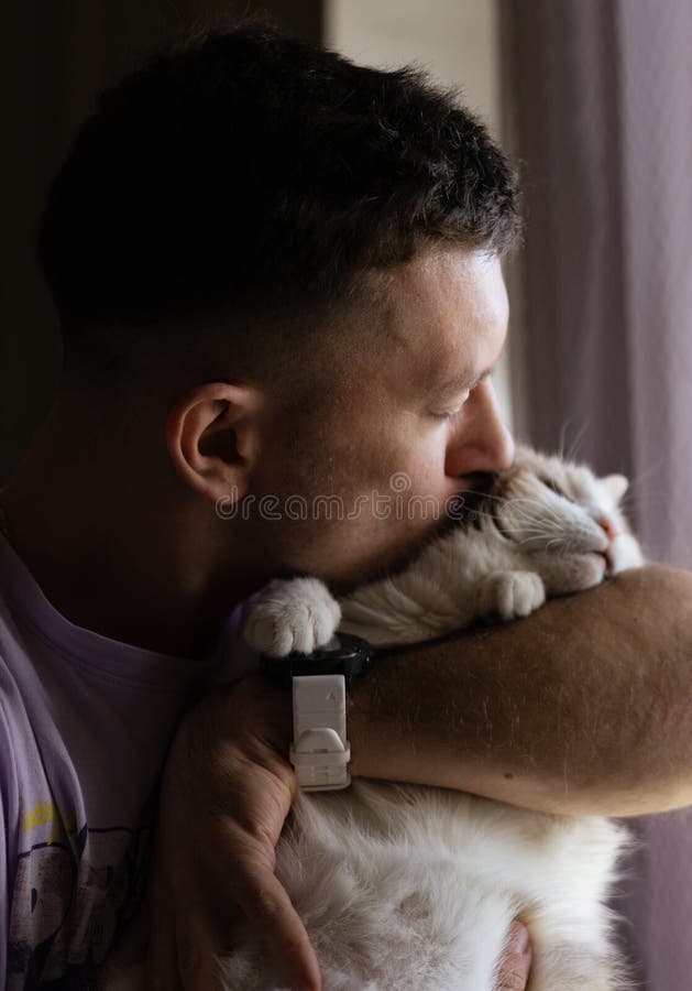Guy kisses his cat stock photo. Image of care, eyes - 374996276