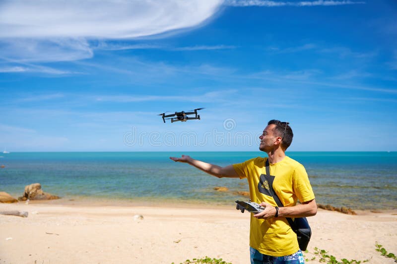 A Guy Launches from the Arm of a Prone on the Seashore Stock Photo ...