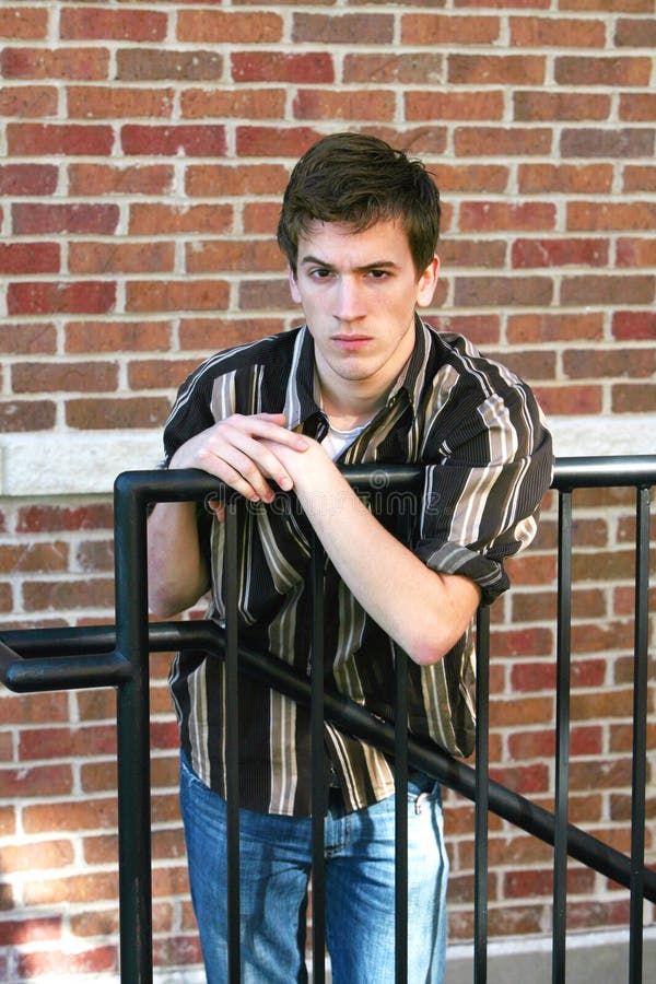 Guy leaning on railing stock photo. Image of portrait - 12001890