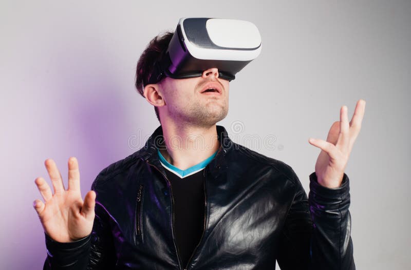 A Guy in a Leather Jacket Plunges into Virtual Reality Using VR Glasses ...