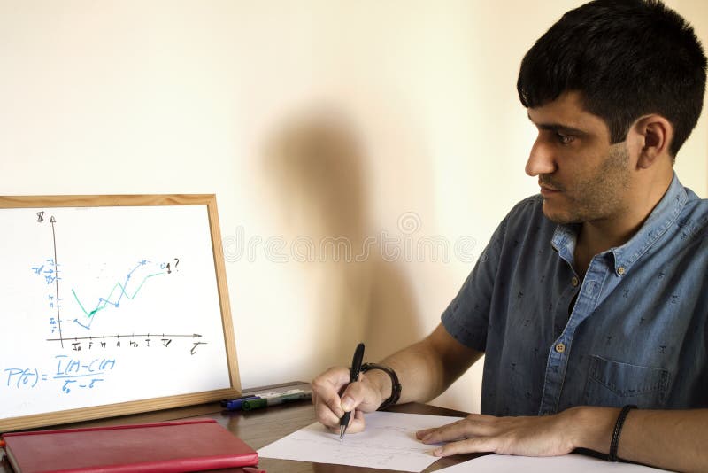 Guy Looking at the White Board and Taking Notes Stock Photo - Image of ...
