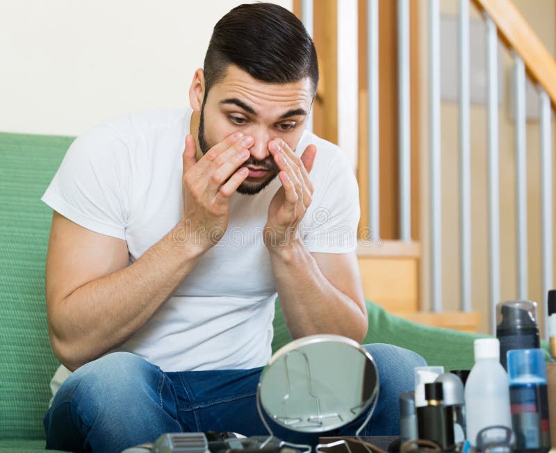 Guy Looking at His Problematic Skin in a Mirror Stock Photo - Image of ...
