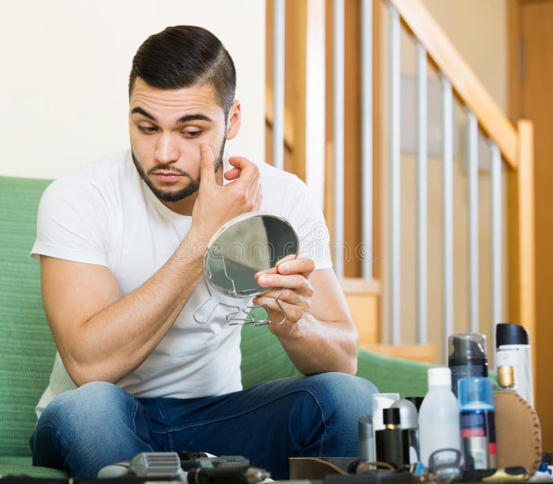 Guy Looking at His Problematic Skin in a Mirror Stock Photo - Image of ...