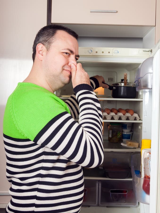 Guy Looking for Something in Pan Near Fridge Stock Photo - Image of ...