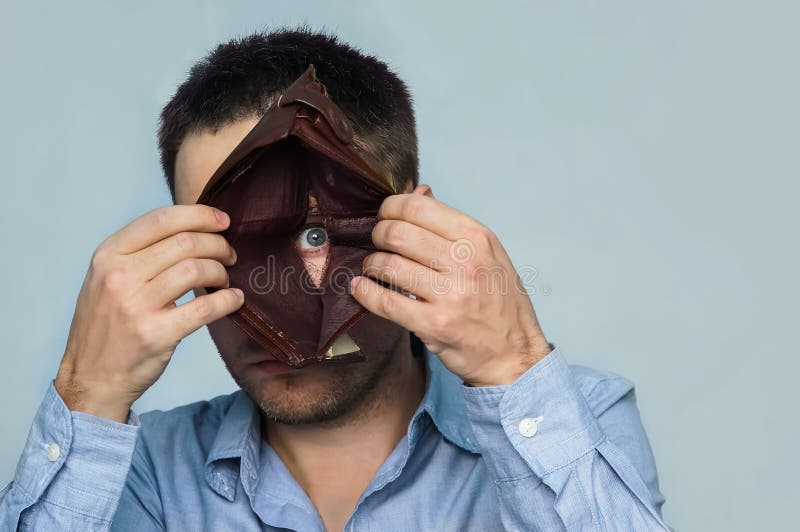 A Guy Looks through a Hole in the Bottom of an Empty Leather Wallet by ...
