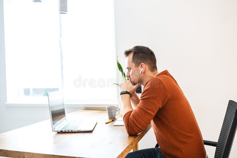 Guy Looks at Laptop and Notes in Notebook Stock Photo - Image of ...