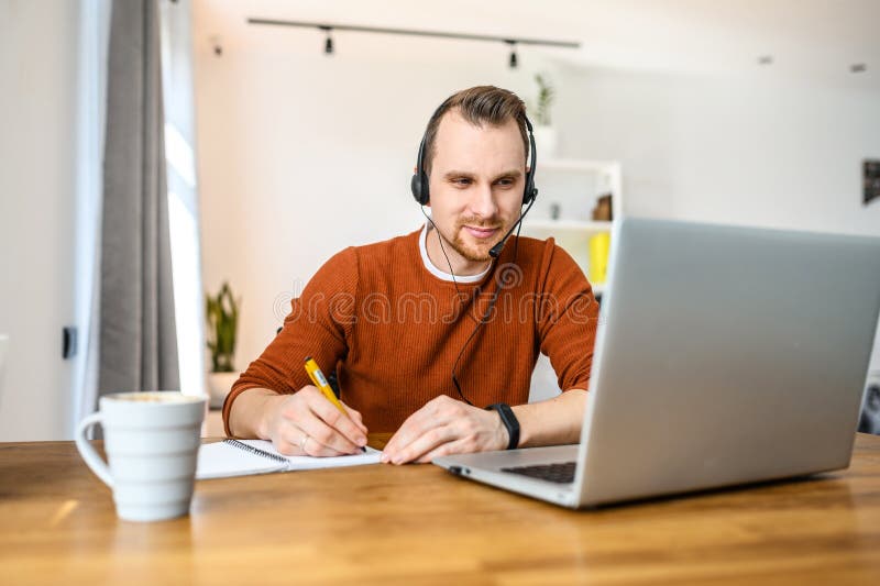 Guy Looks at Laptop and Notes in Notebook Stock Image - Image of ...