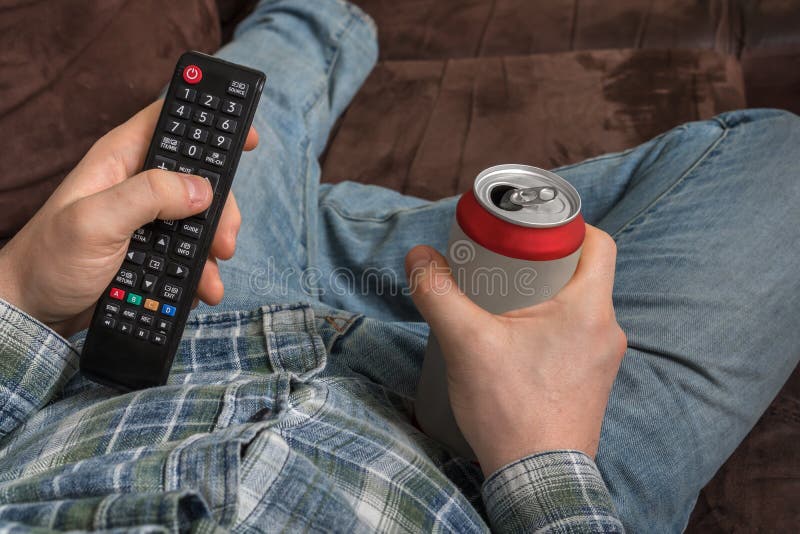 Guy is Lying on Sofa with TV Remote Control and Drinking Beer Stock ...