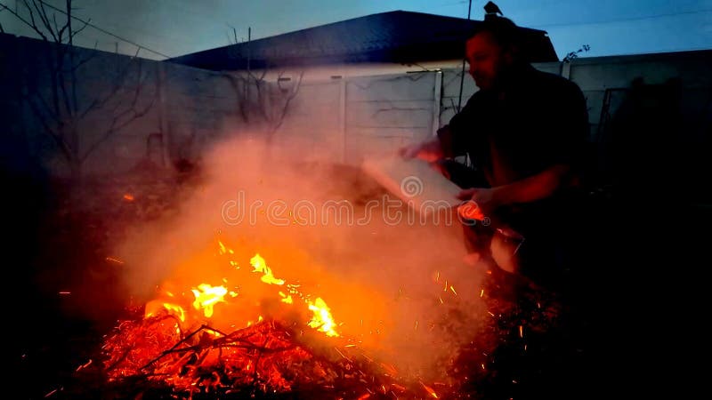 A Guy Makes Fire Outside Ash Danger Stock Footage - Video of light ...