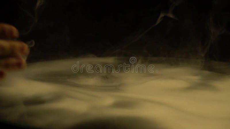 A Guy Makes a Twister from a Smoke on a Round Mirror Stock Footage ...